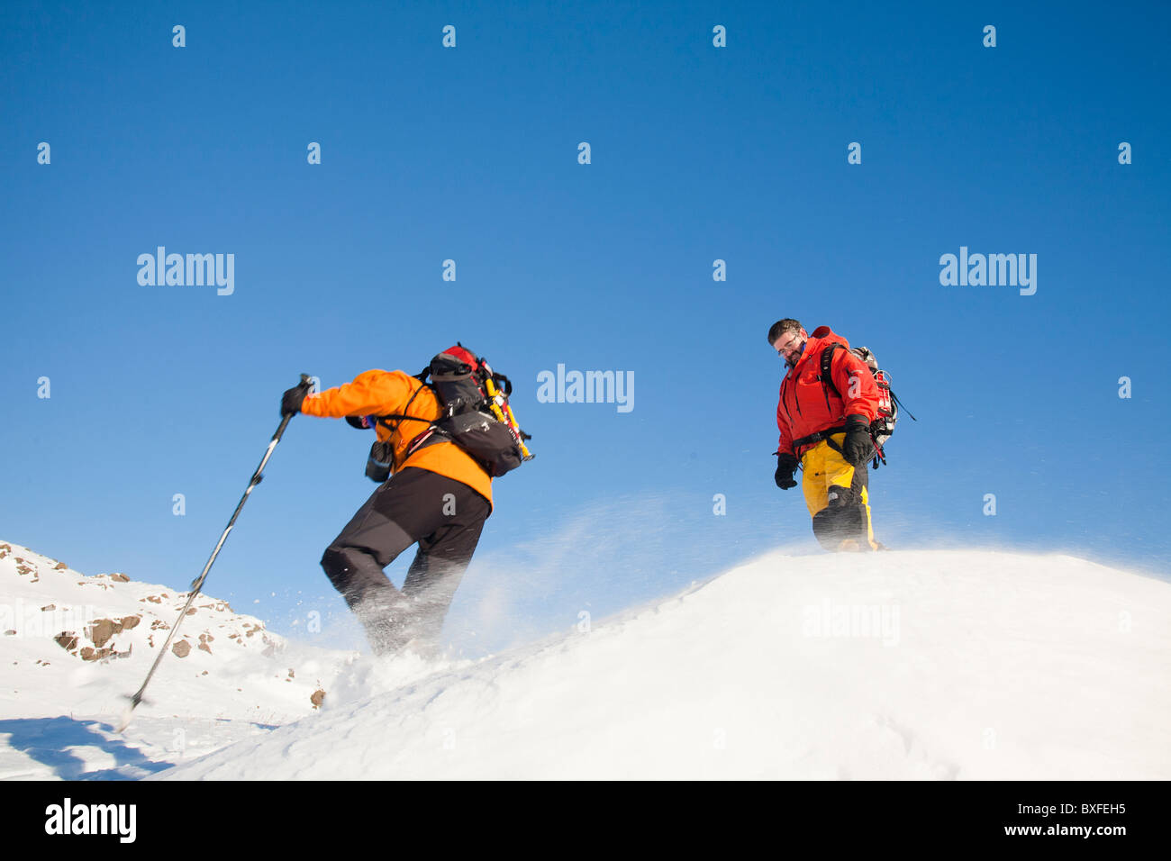 Climbers being blasted by spindrift during high winds moving snow above ...
