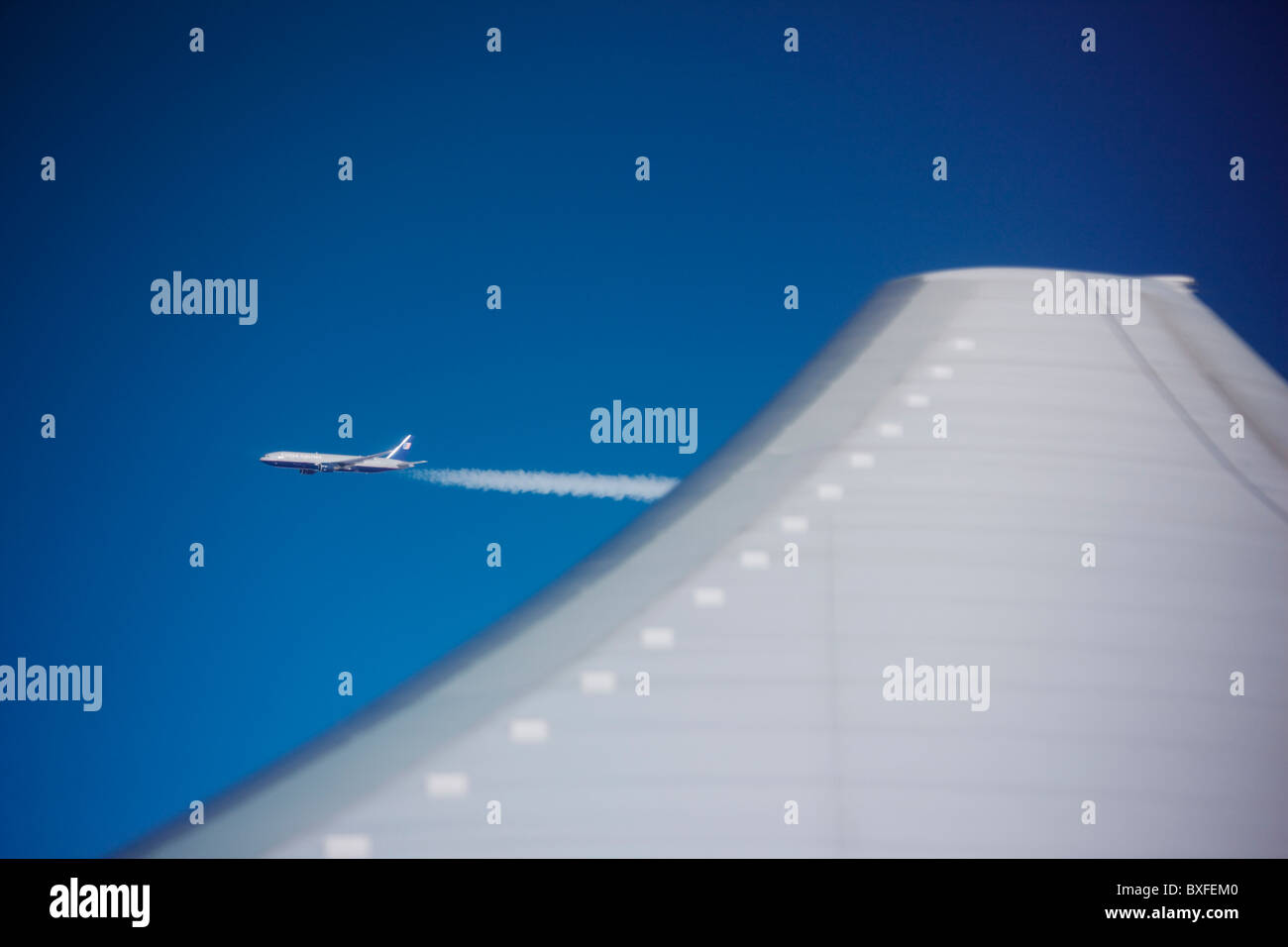 Passenger jet aircraft viewed across plane wing from porthole of ...