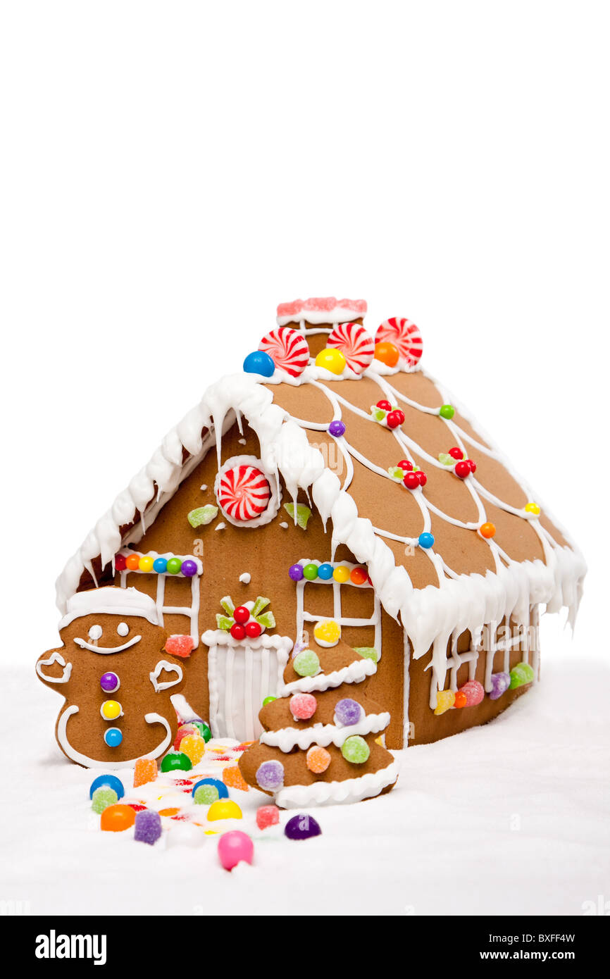Gingerbread house, man and Christmas tree covered with snow and ...