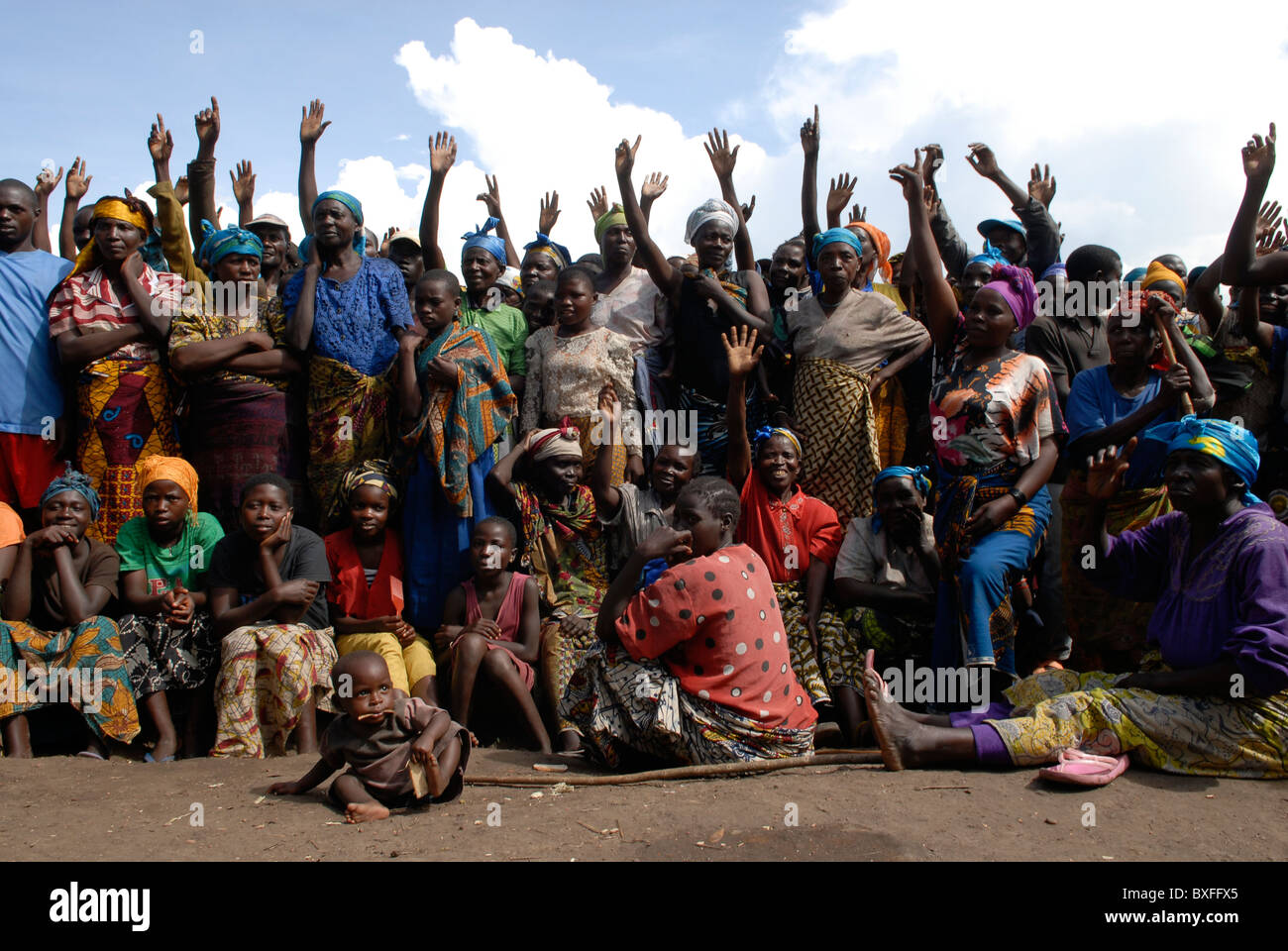 Displaced Congolese people raise their hands in an IDP camp in North ...