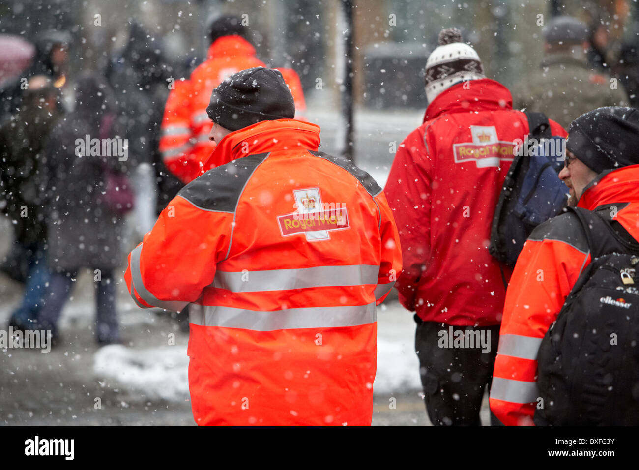 royal mail postmen out walking on a cold snowy winters day Belfast ...