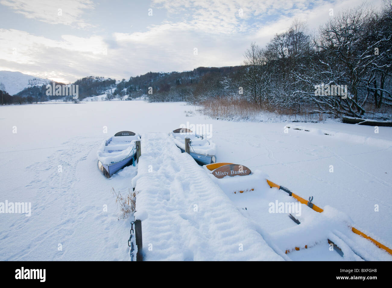 Rowing boats frozen into the ice on Grasmere in the Lake District, UK ...