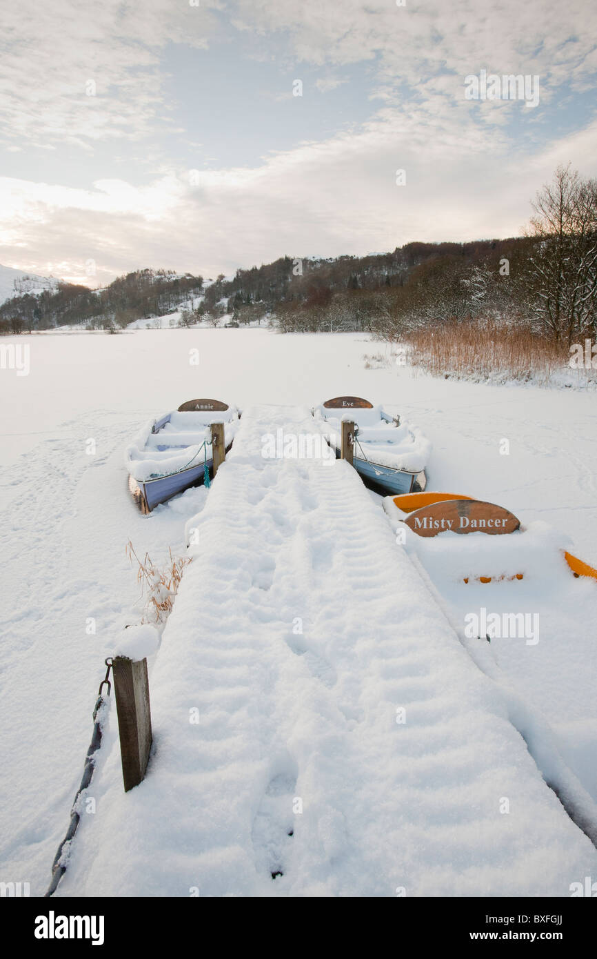 Rowing boats frozen into the ice on Grasmere in the Lake District, UK ...