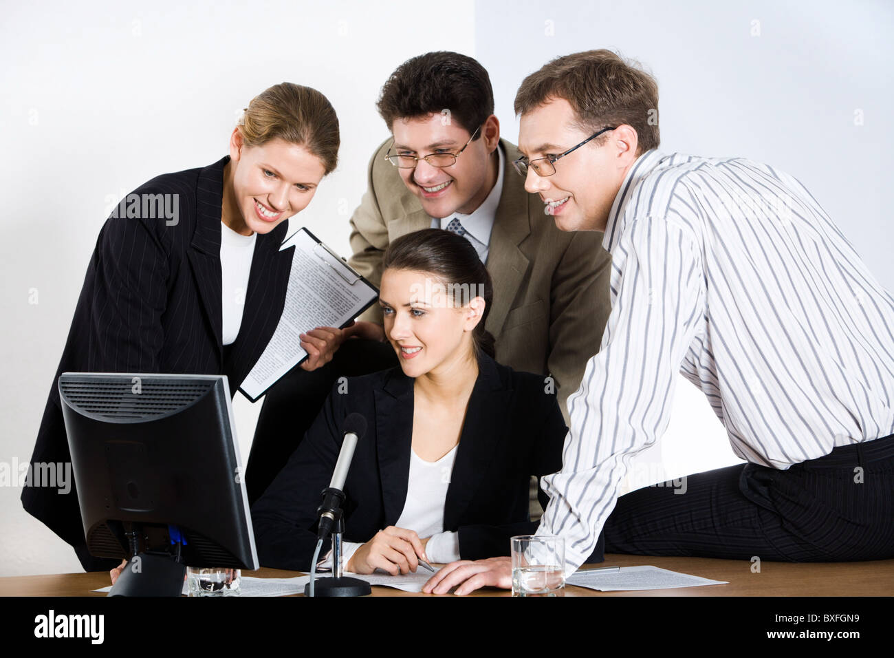 Team of four business people working together Stock Photo - Alamy