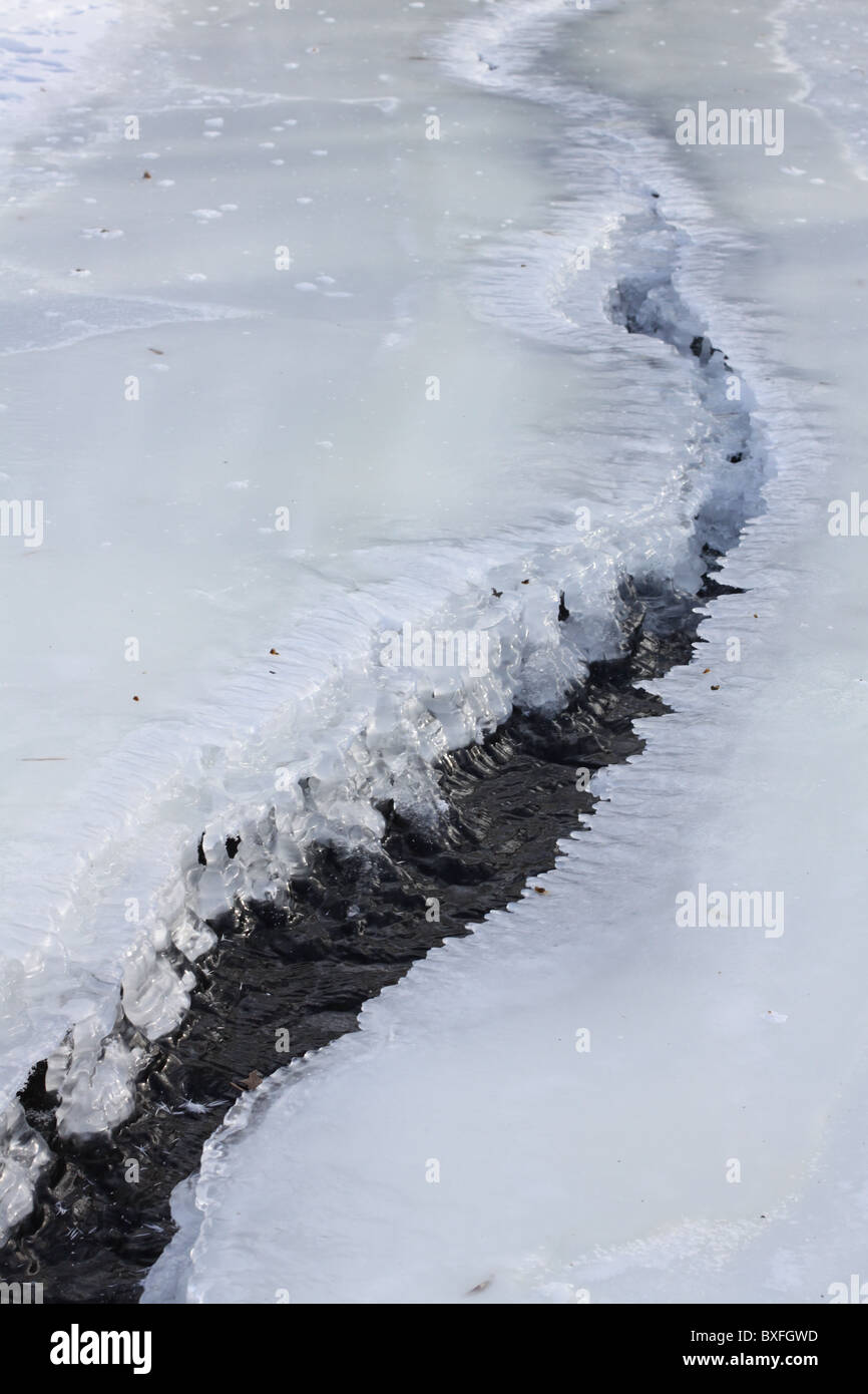 A crack in the ice of a creek Stock Photo - Alamy