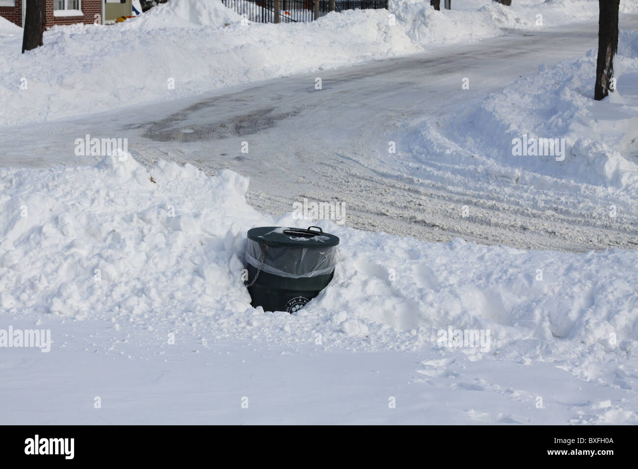 A trash can buried in snow on a street corner in Minneapolis, Minnesota ...