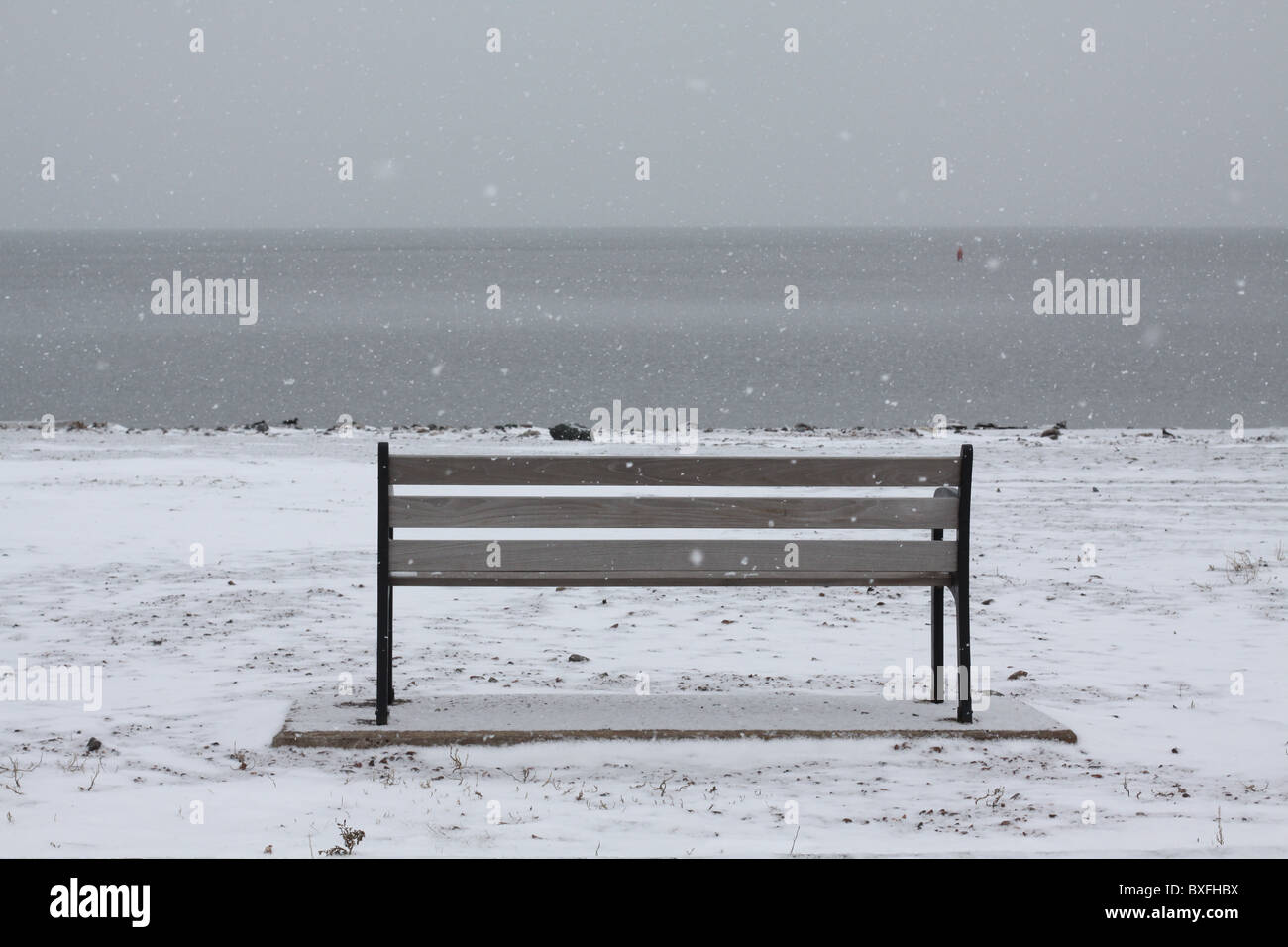 An empty bench facing Lake Superior in the winter Stock Photo - Alamy