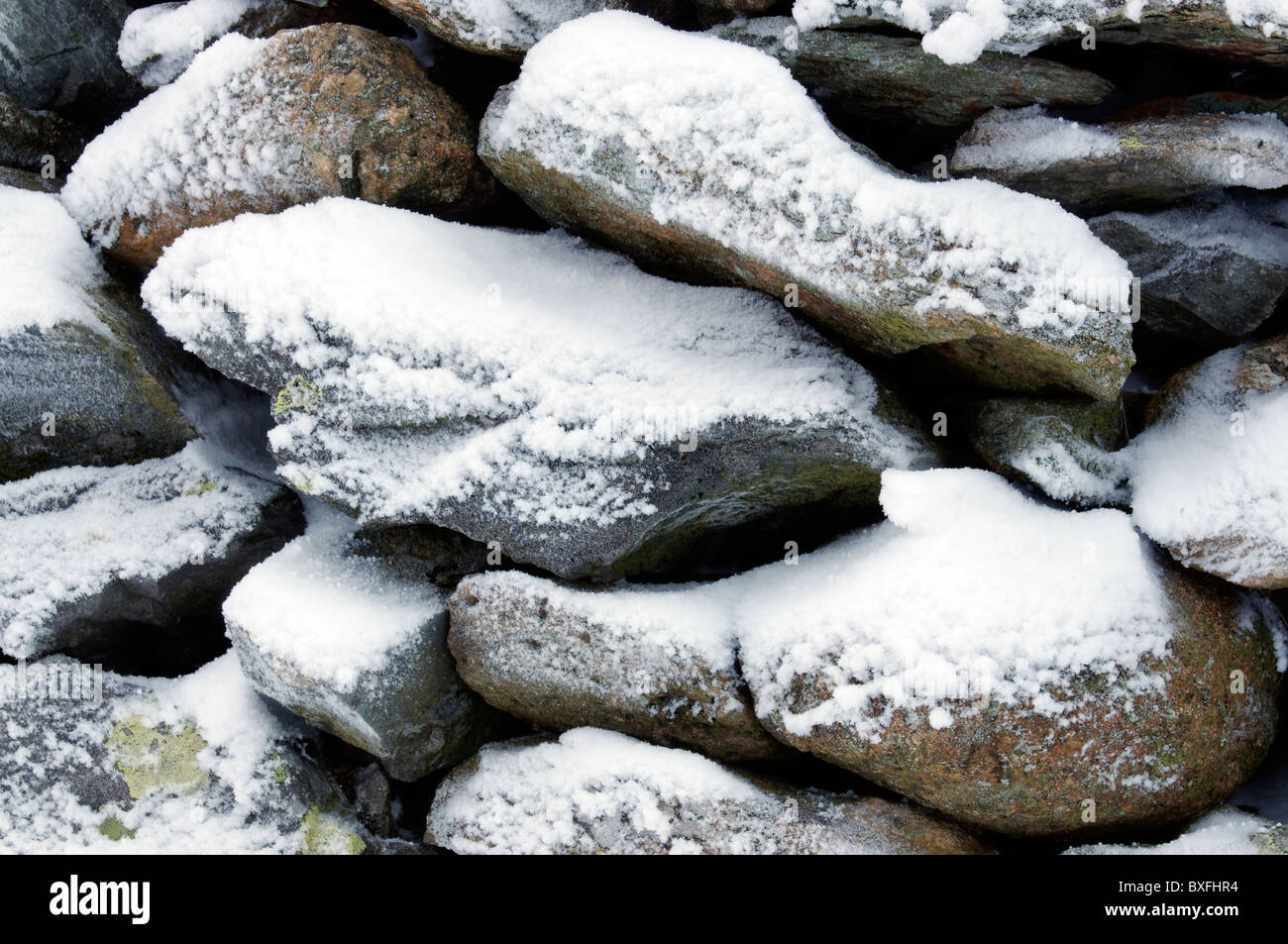 Snow on a stone wall Stock Photo - Alamy