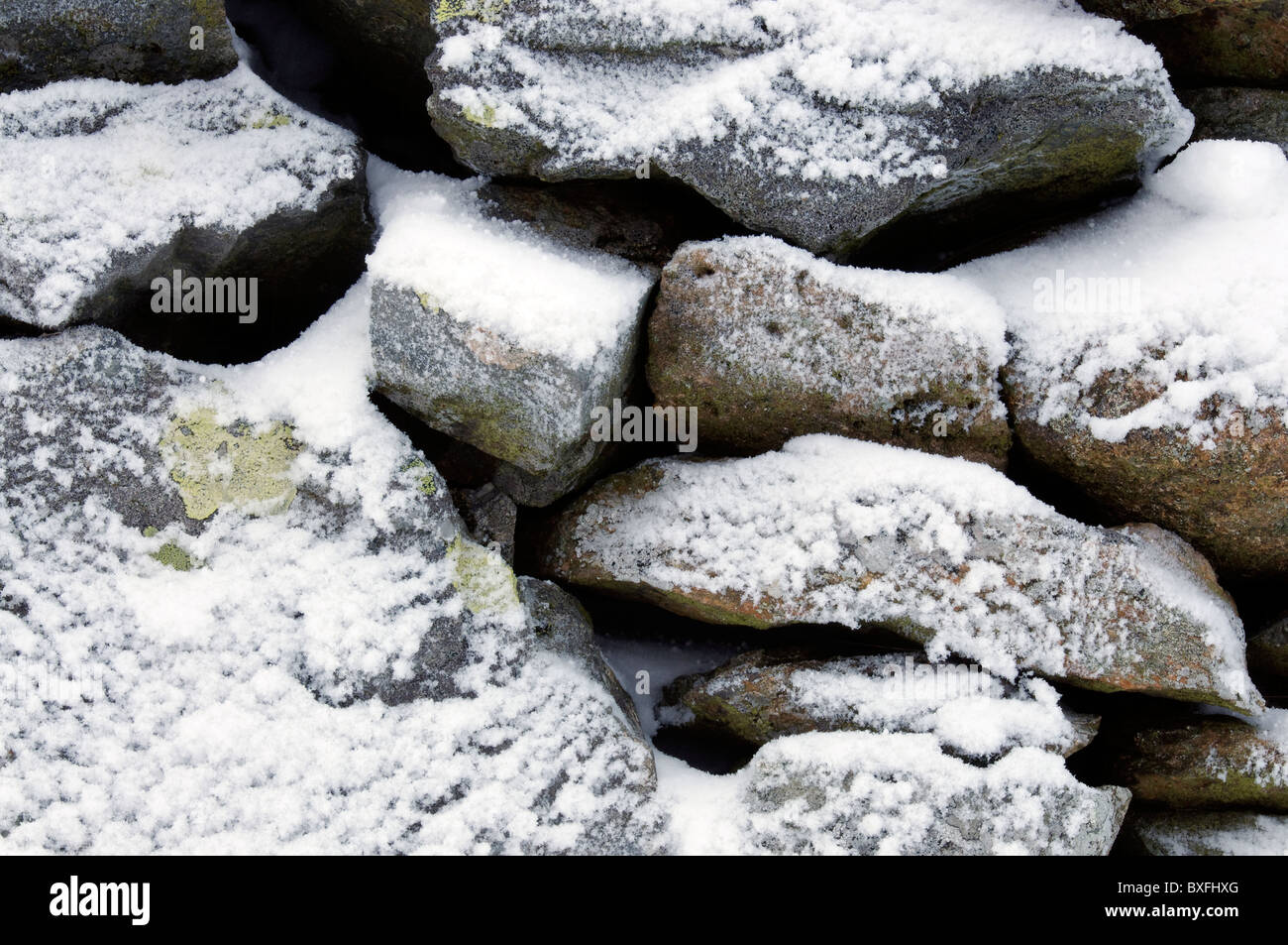 Snow on a stone wall Stock Photo - Alamy