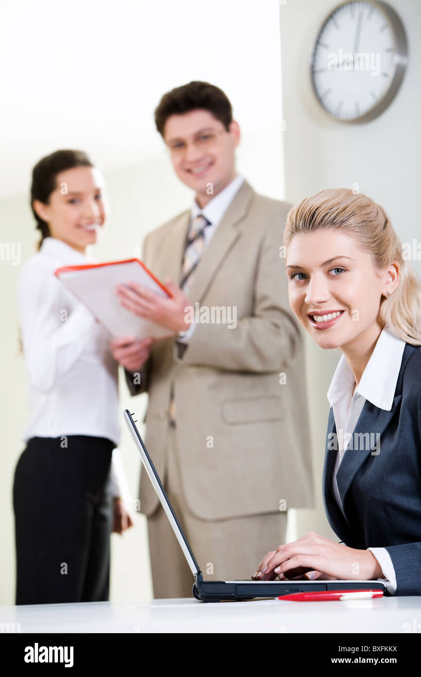Portrait of representative woman on the background of her business team ...