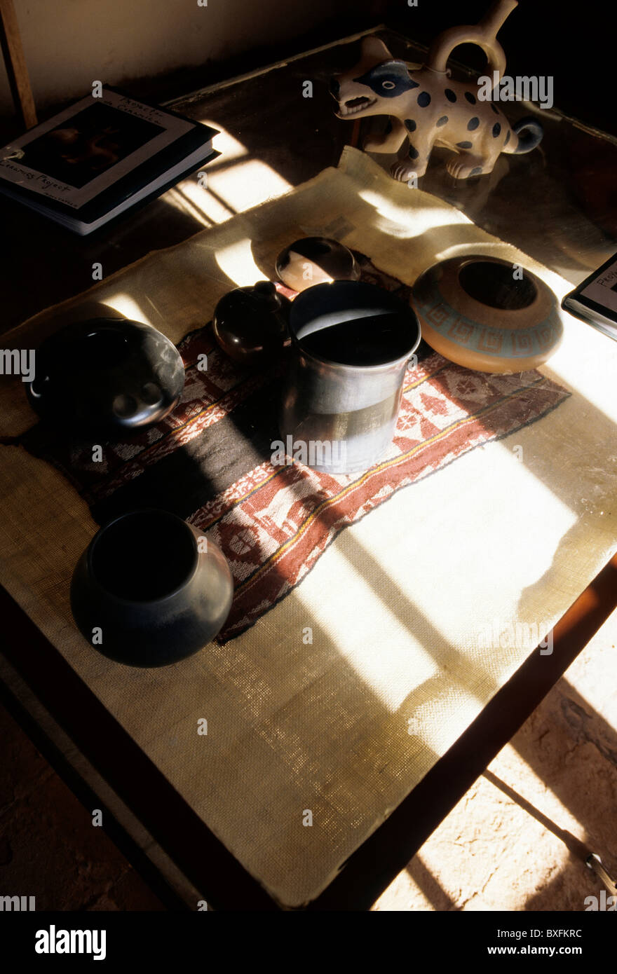 Potter working on pottery with Incan designs in artists' workshop in ...