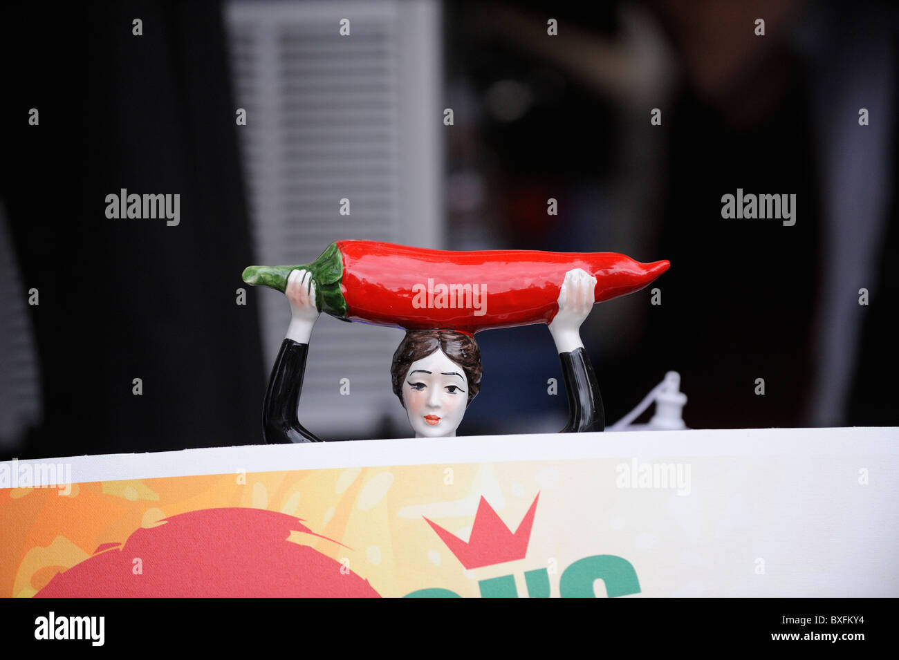 Ceramic figurine of a woman holding a large chili on her head Stock ...