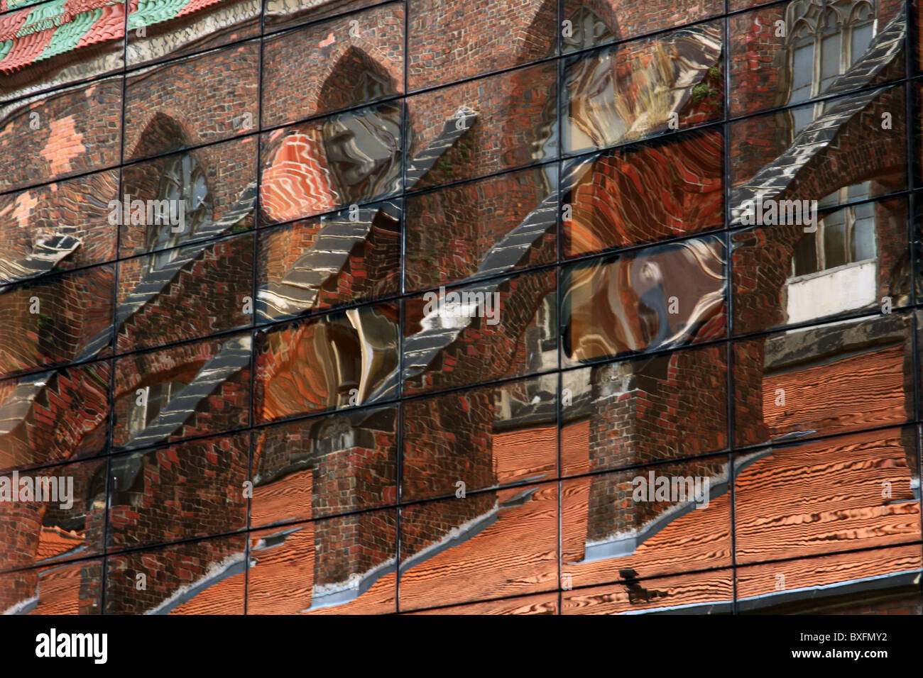 St Mary Magdalene church reflected in the modern glass building ...