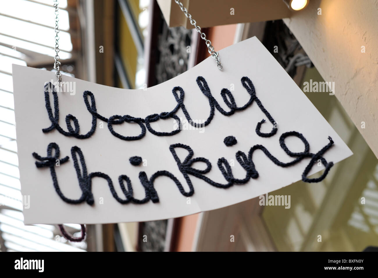 Cute knitted shop sign with the words woolly thinking in black wool ...