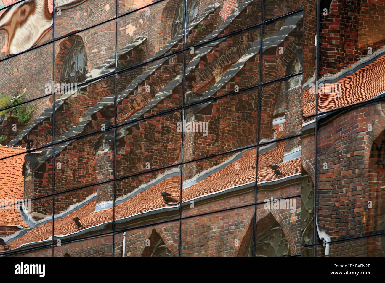 St Mary Magdalene church reflected in the modern glass building ...