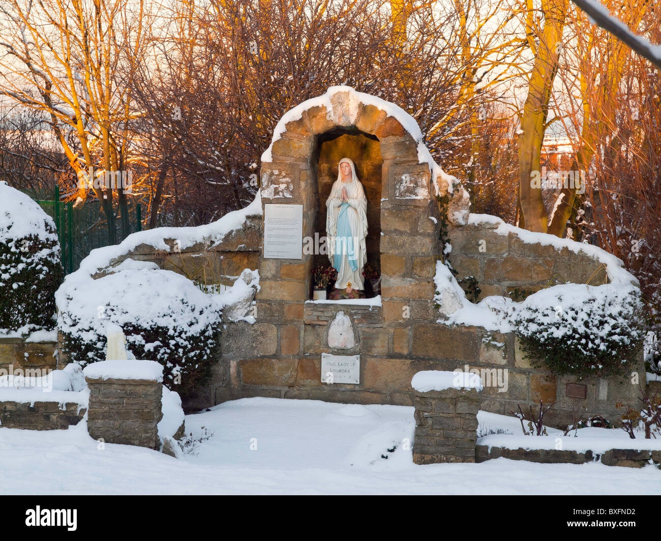 Statue of Our Lady of Lourdes in the grounds of the Catholic Church at ...