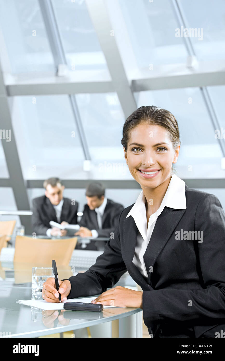 Portrait of friendly beautiful woman sitting at the glassy table Stock ...
