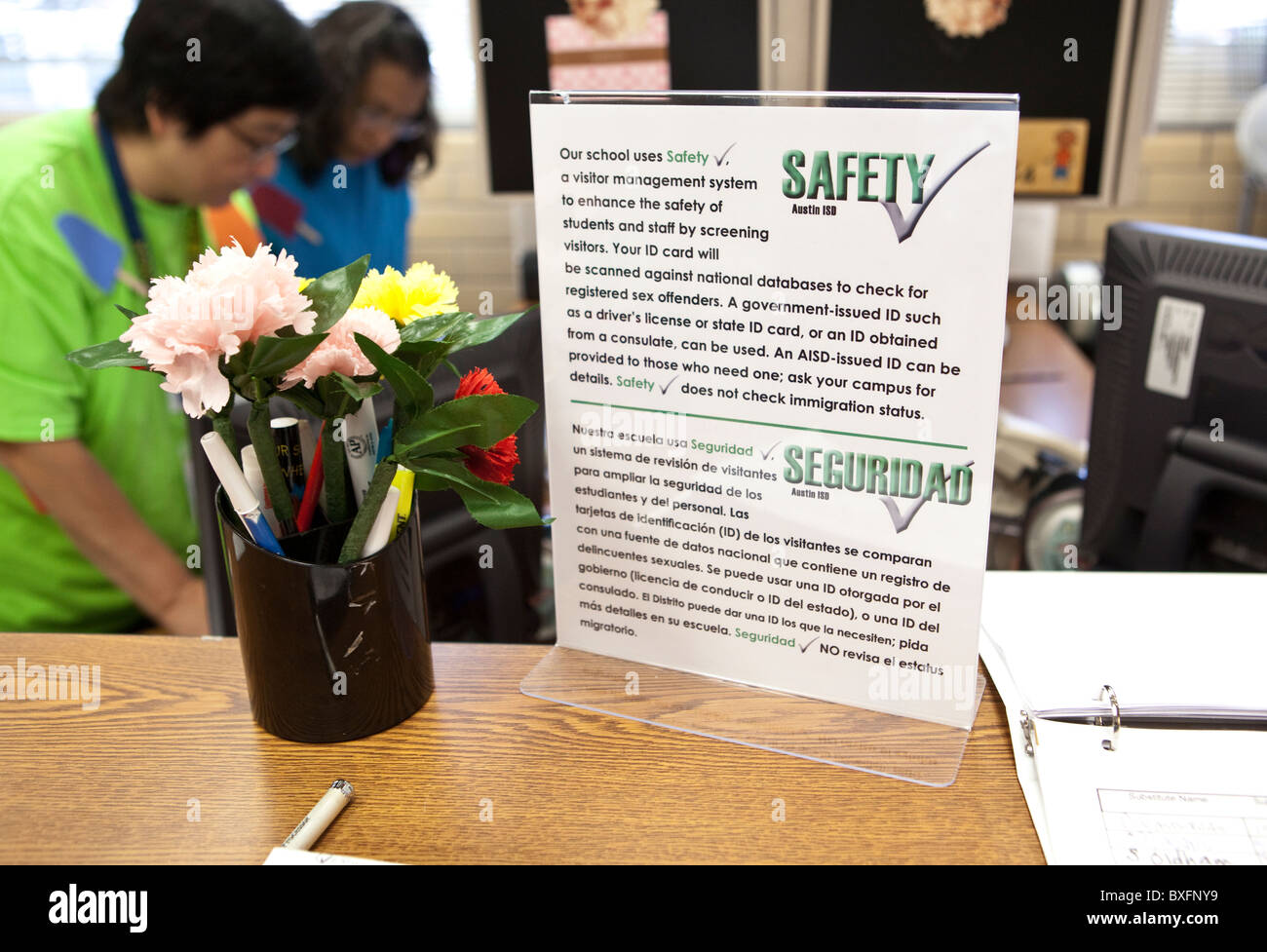 Bilingual sign in office explains security procedures required for ...