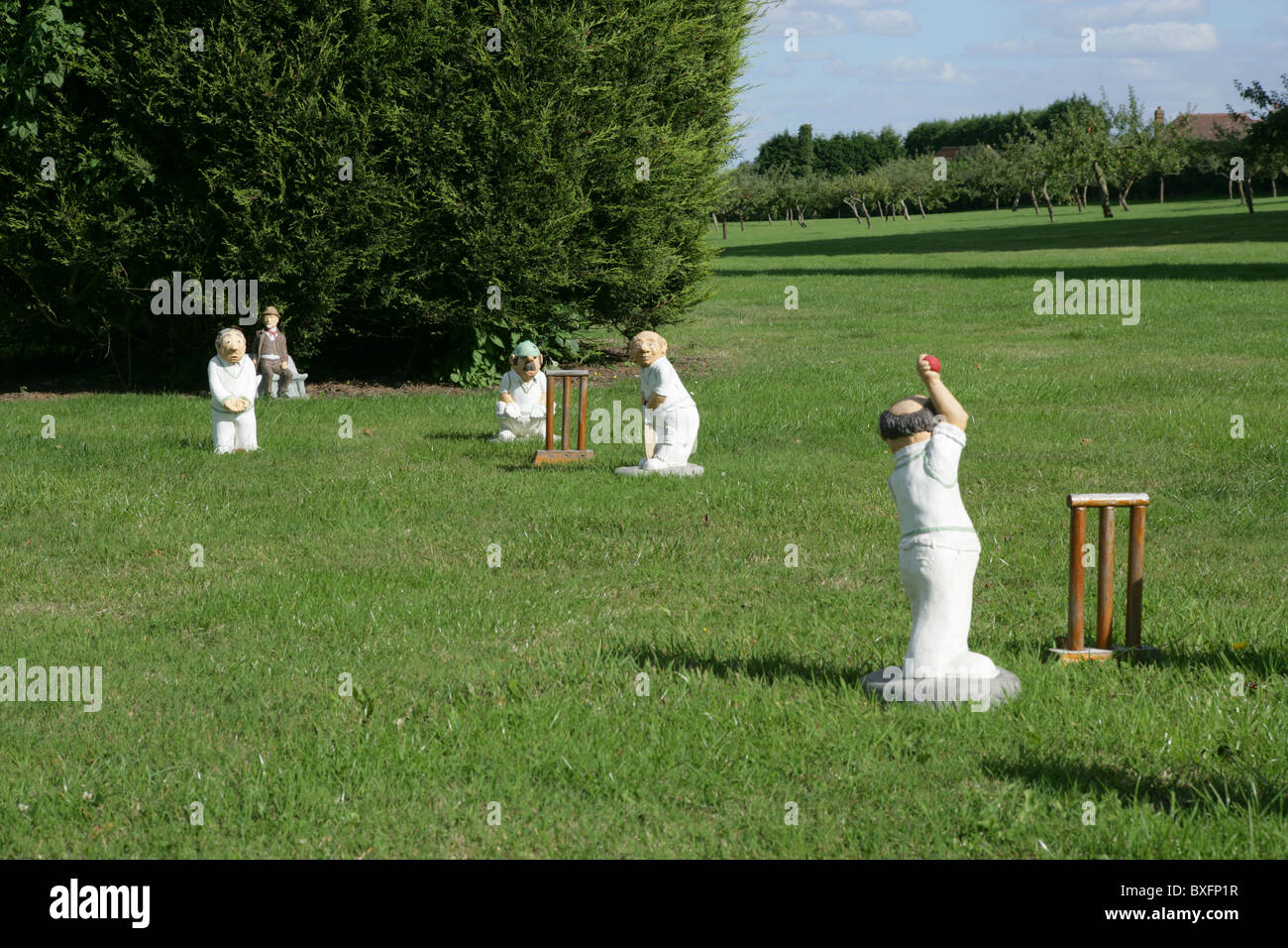 Model cricket match, landscape: bowler bowling, batter facing ...