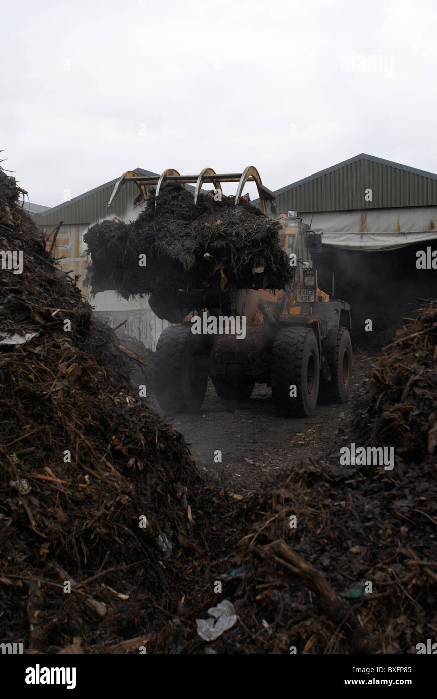 Front loader working at composting centre Stock Photo - Alamy