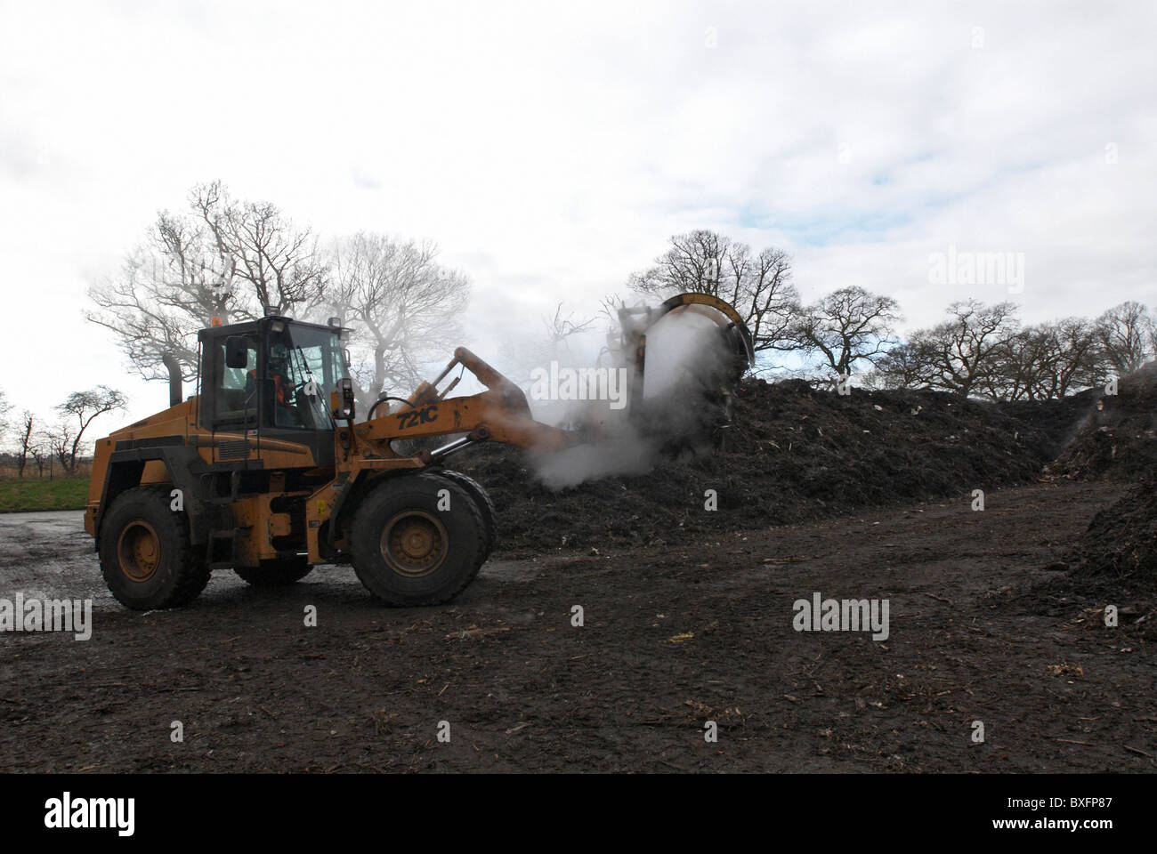 Front loader working at composting centre Stock Photo - Alamy