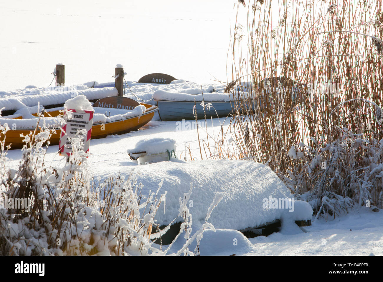 Rowing boats frozen into the ice on Grasmere in the Lake District, UK ...
