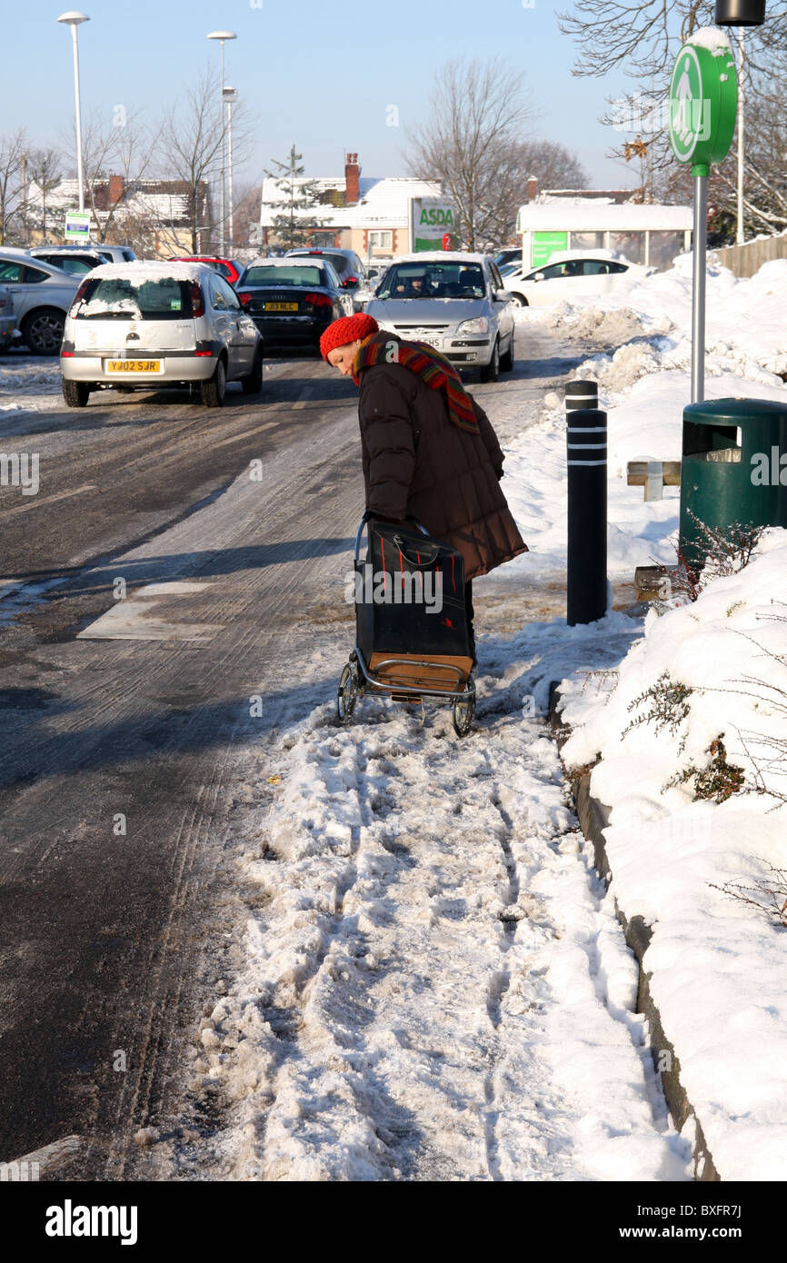 Old lady pulling trolley hi-res stock photography and images - Alamy