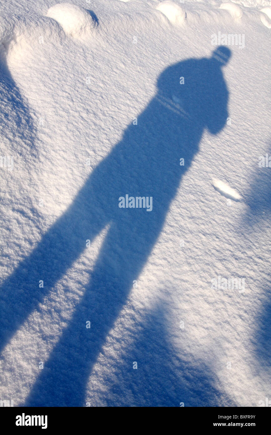 Snow shadows, white-out conditions with long legs shadows across the ...