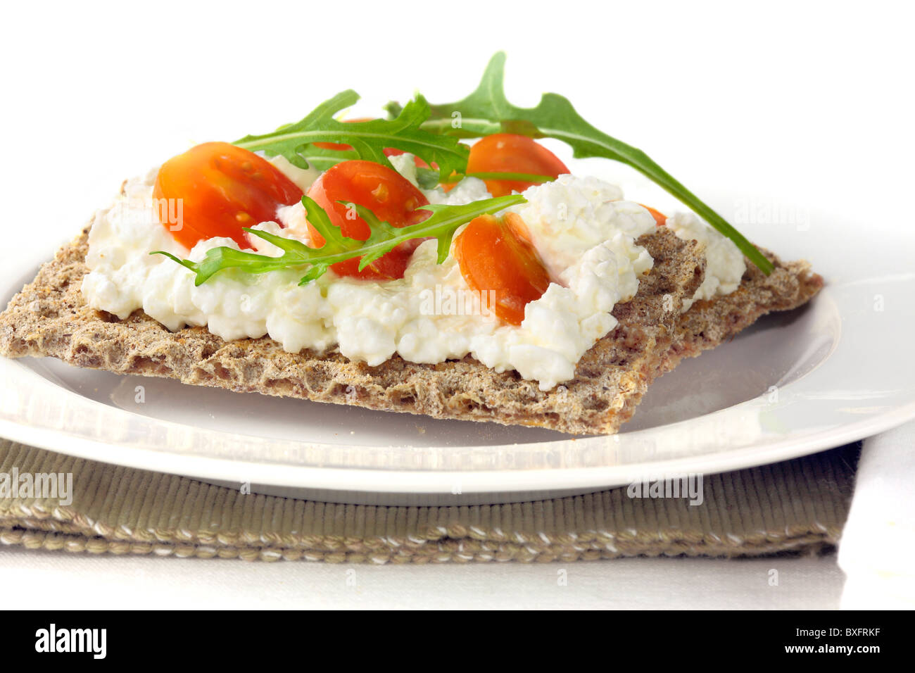 Ryvita with cottage cheese and tomato and rucola Stock Photo - Alamy