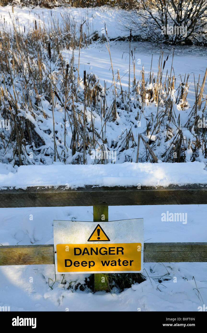 frozen pond & warning sign Stock Photo - Alamy