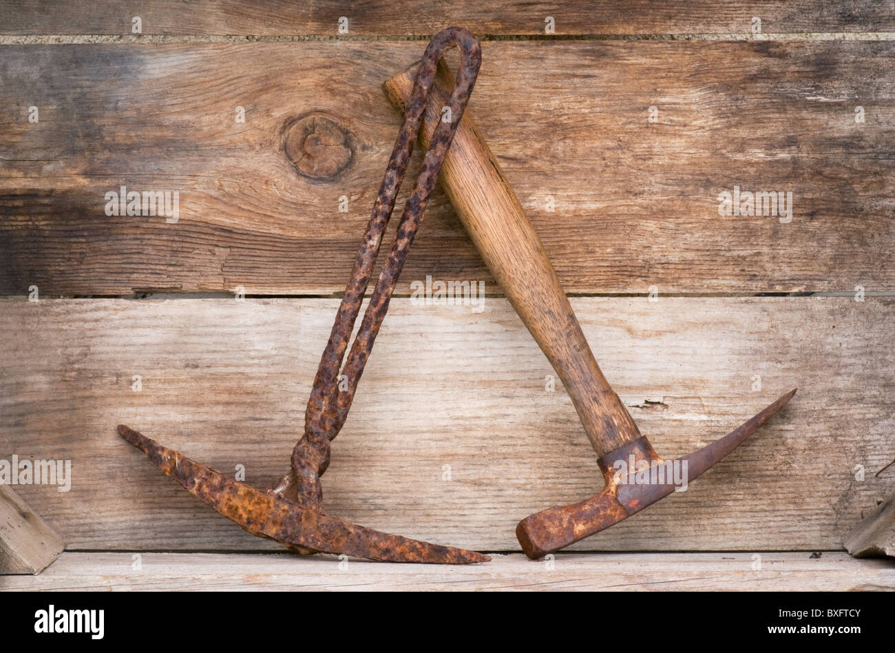 2 old rusty used mining picks on wood shelf Stock Photo - Alamy
