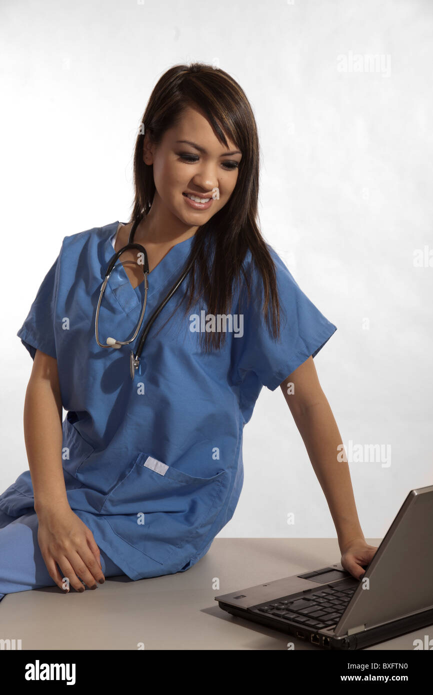 Filipino nurse doctor working on laptop computer Stock Photo - Alamy