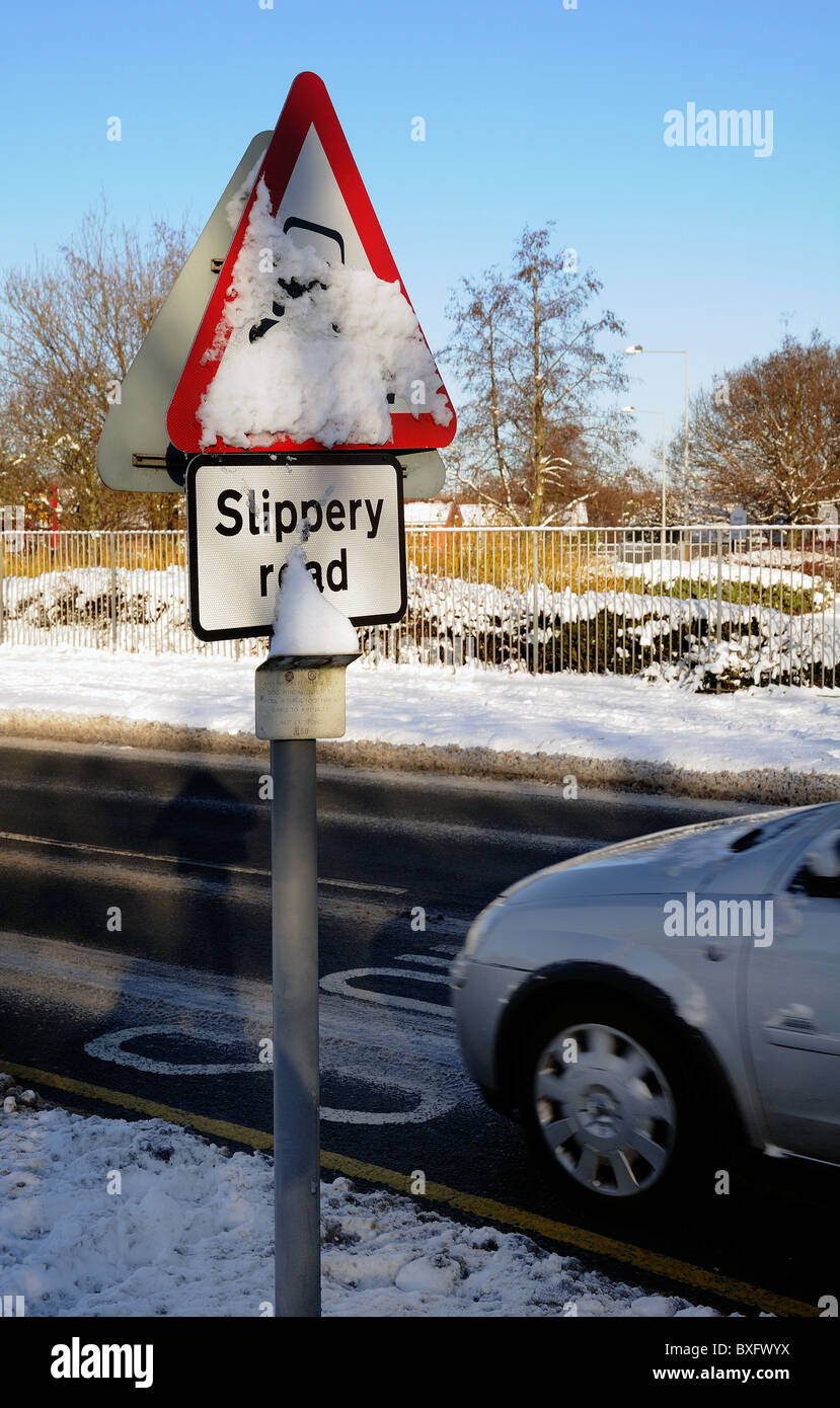 snow on hazard warning signpost Stock Photo - Alamy