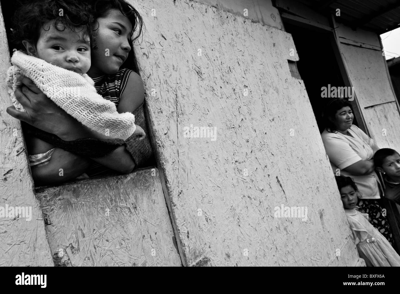 A displaced woman with her four children lives in a wooden house in the ...