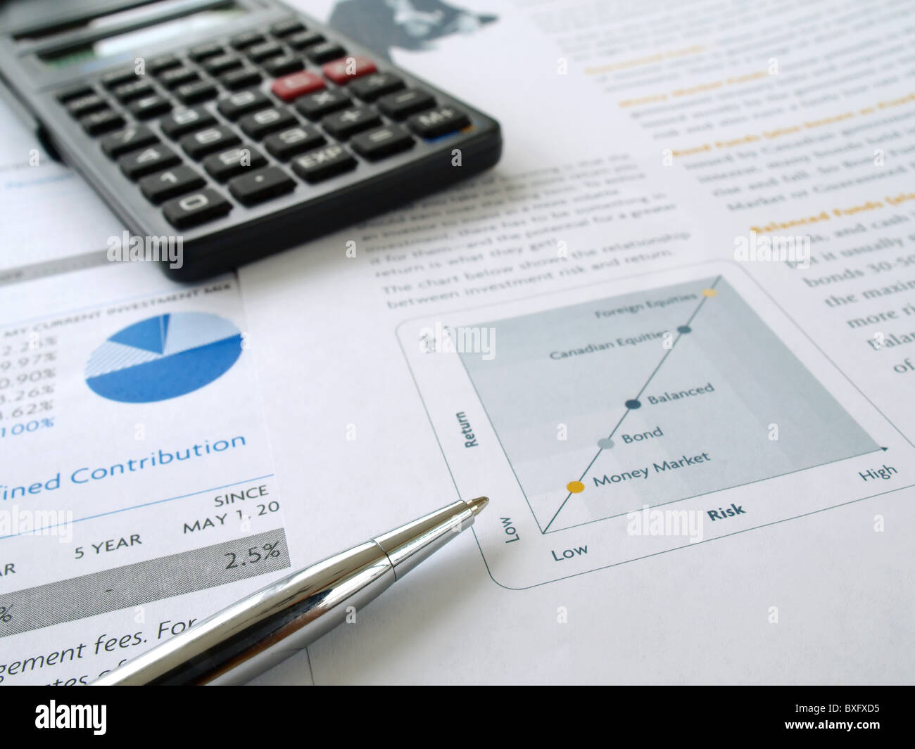 Pen on the investment chart with calculator Stock Photo - Alamy