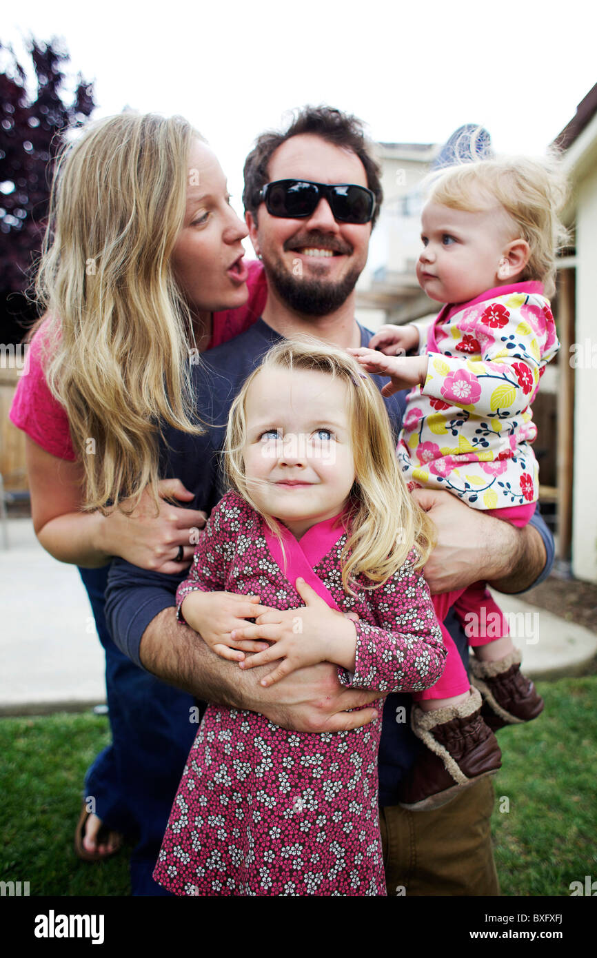 Caucasian family standing in backyard Stock Photo - Alamy