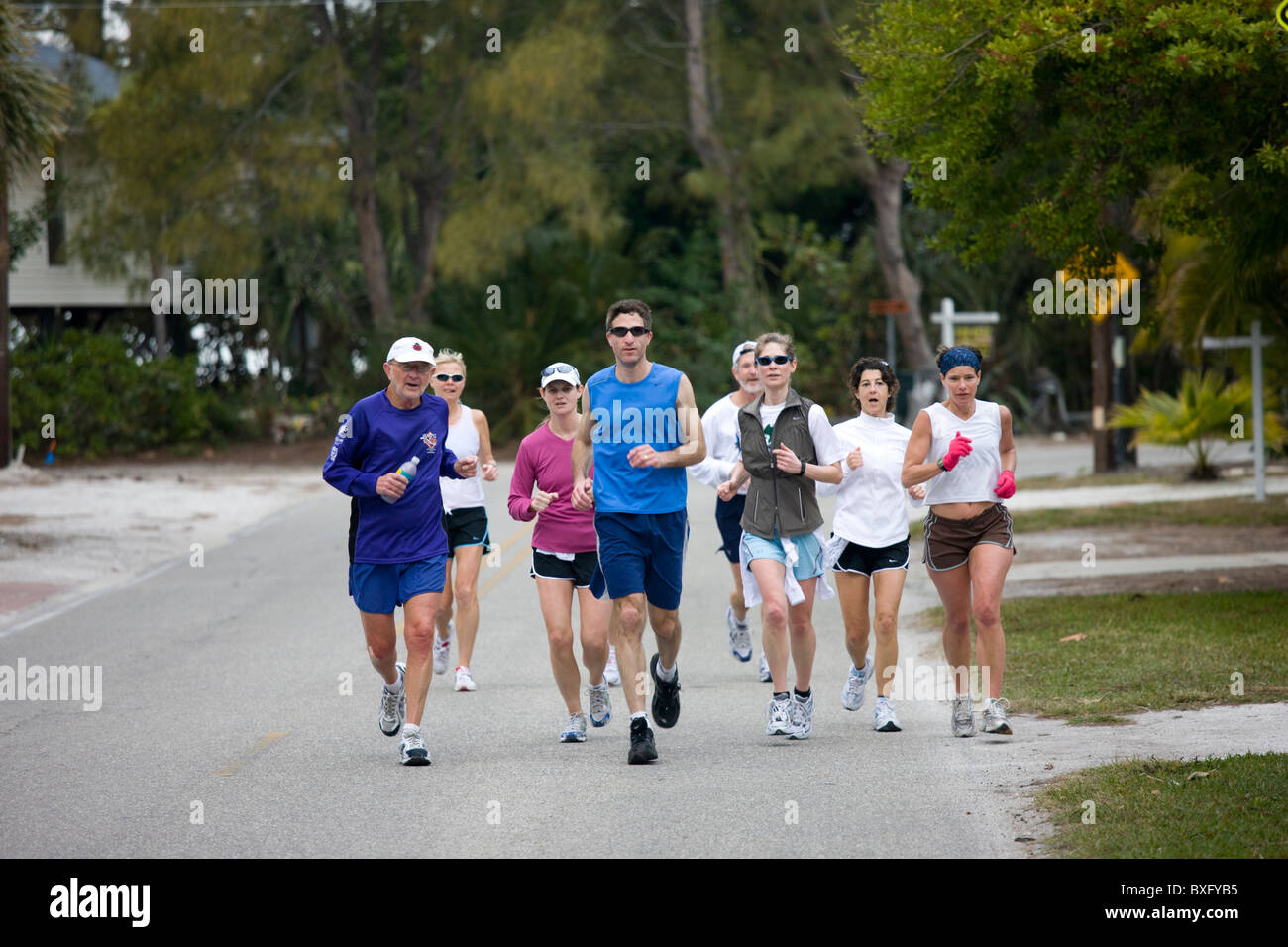 Group of joggers keeping fit on early morning jog, Anna Maria Island ...