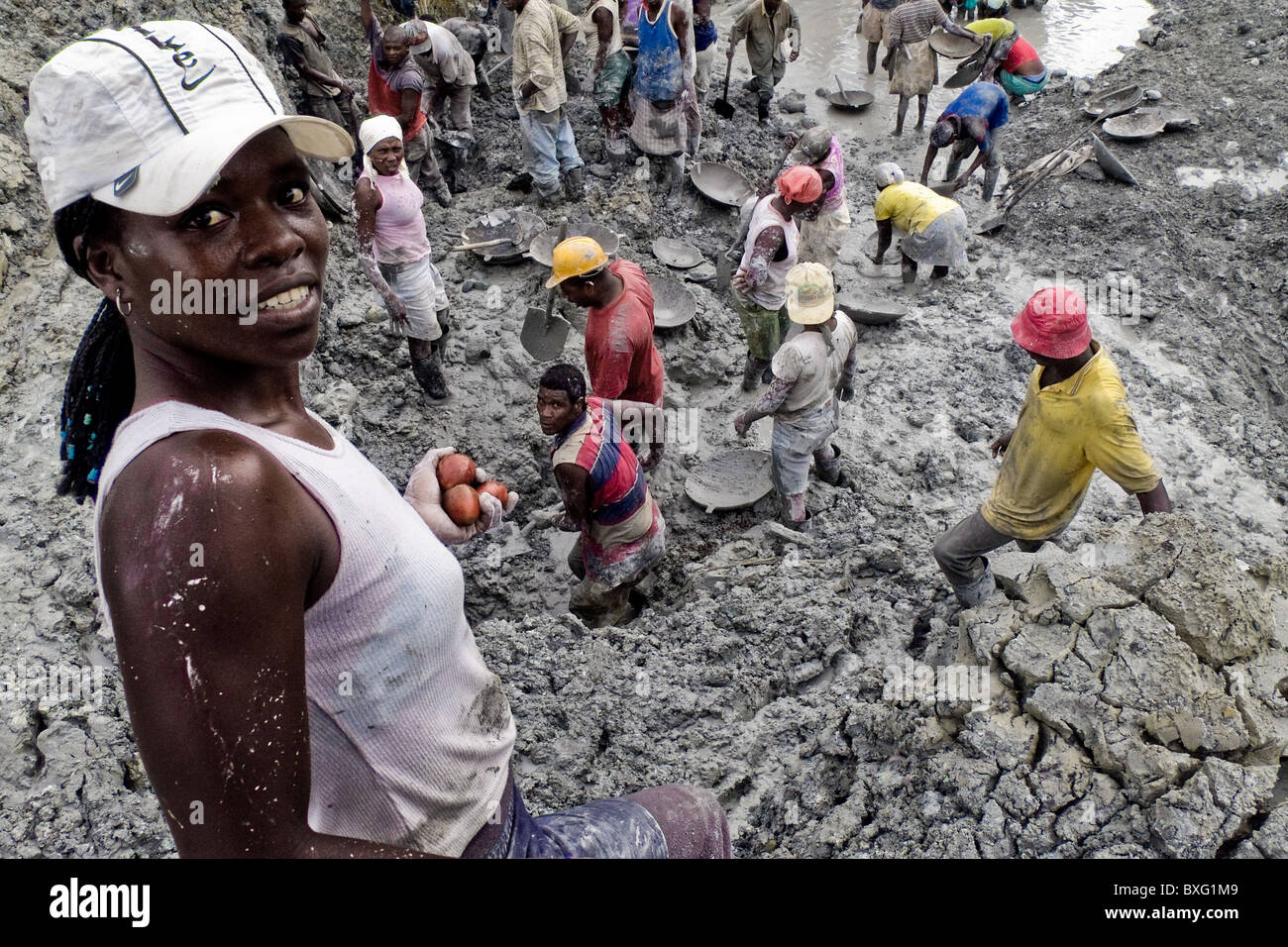 Hundreds of women miners digging the goldbearing mud to find gold and ...