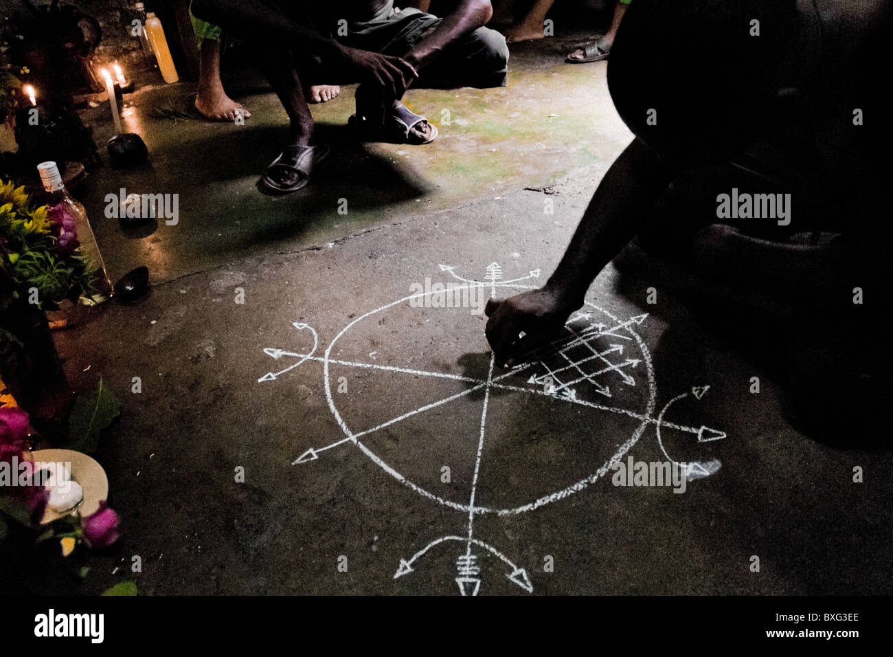 A Cuban man, the Palo religion follower, draws a magical symbol on the ...