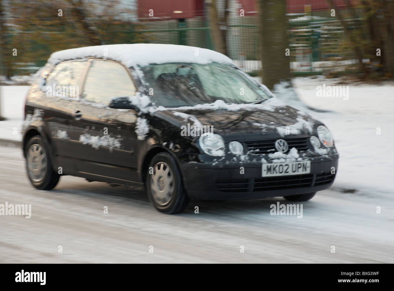 car making its way down a snowy road Stock Photo - Alamy