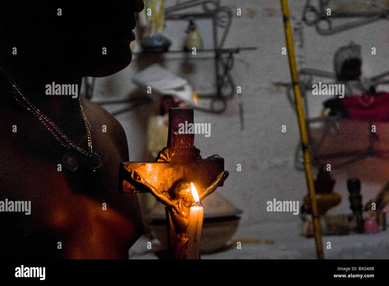 A Cuban man, the Palo religion follower, holds the Christian cross ...