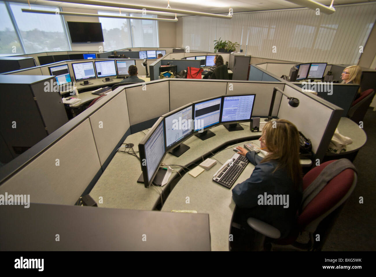 Police dispatchers work at computer consoles handling incoming phone ...