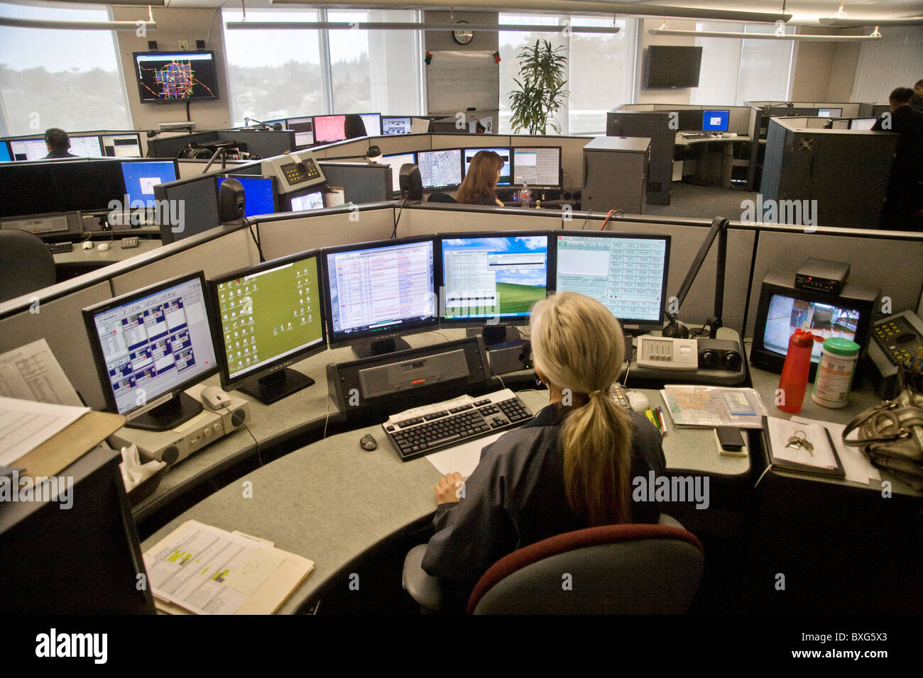 Police dispatchers work at computer consoles handling incoming phone ...