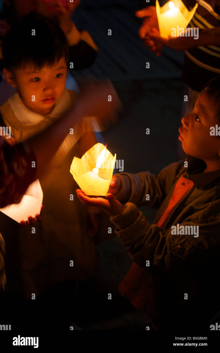 boy and girl with a candle, and light for the myanmar light festival ...