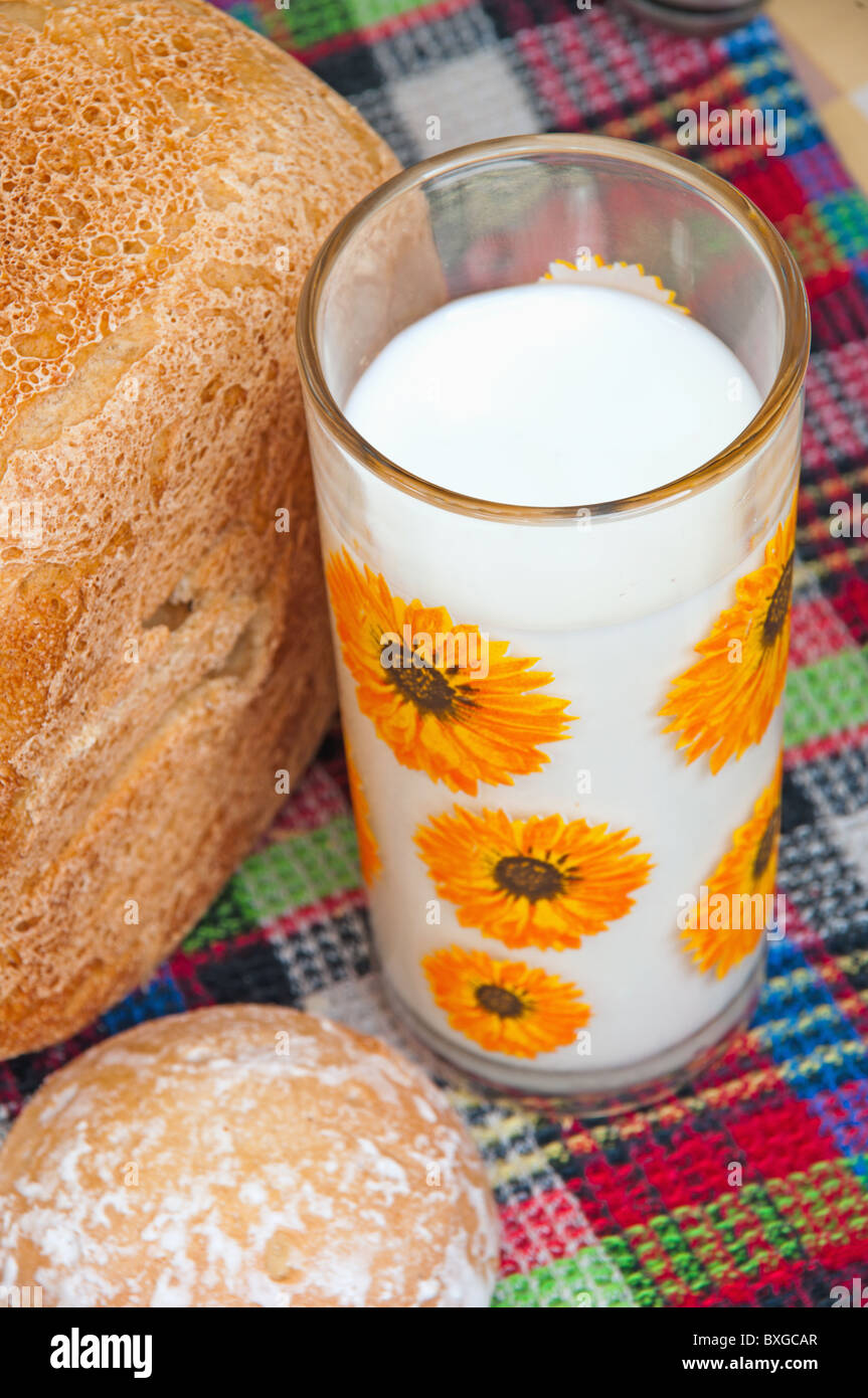 Beaker with milk on a dark blue cloth with cookies on a background ...