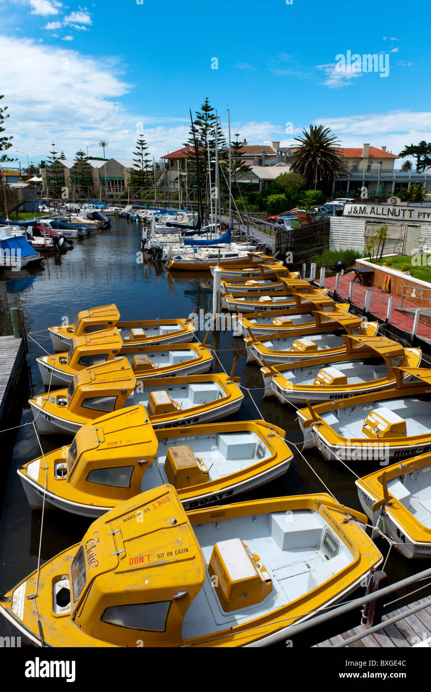 Yellow boats lined up in a marina Stock Photo - Alamy