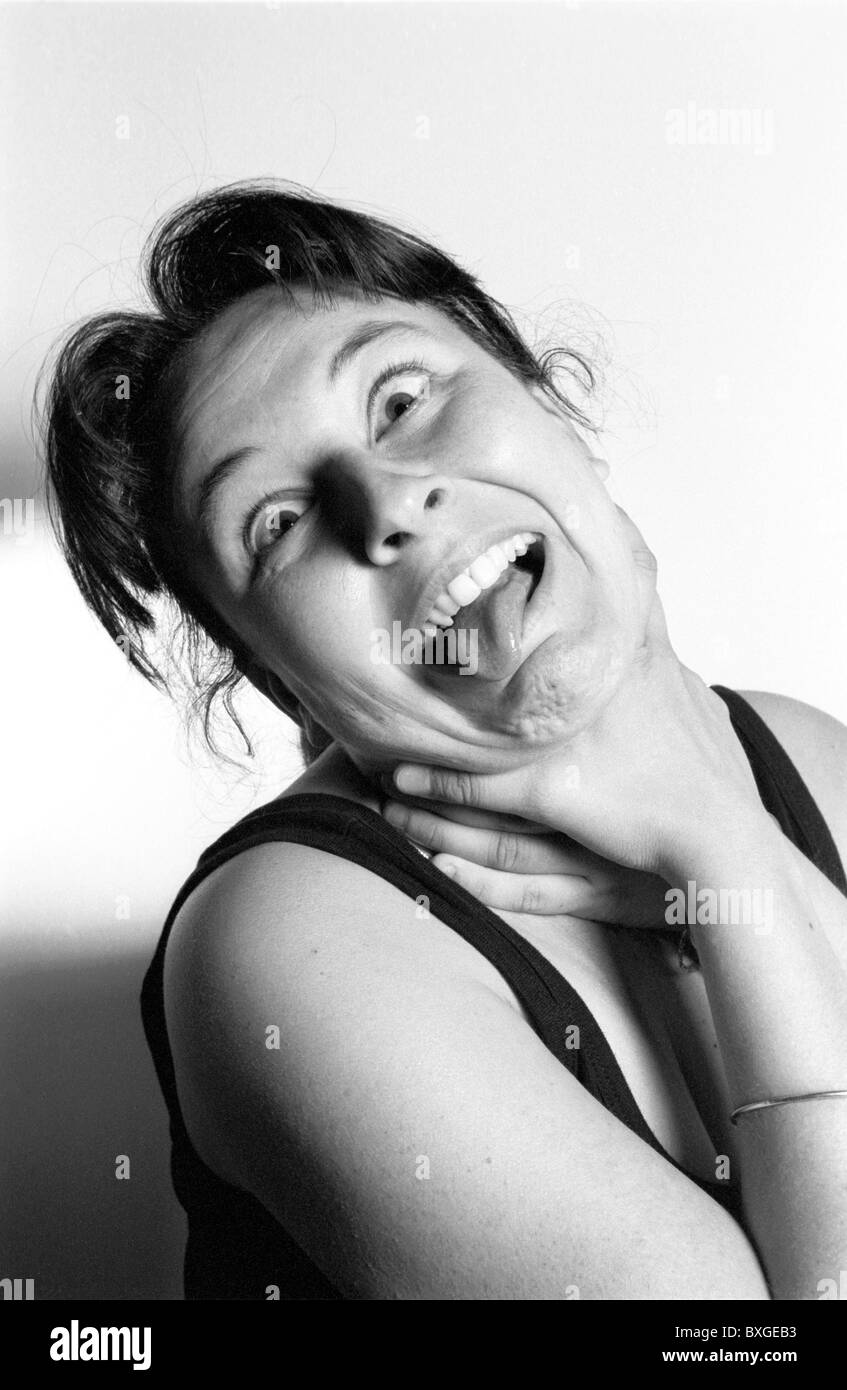 Woman tongue out looking at camera Black and White Stock Photos ...