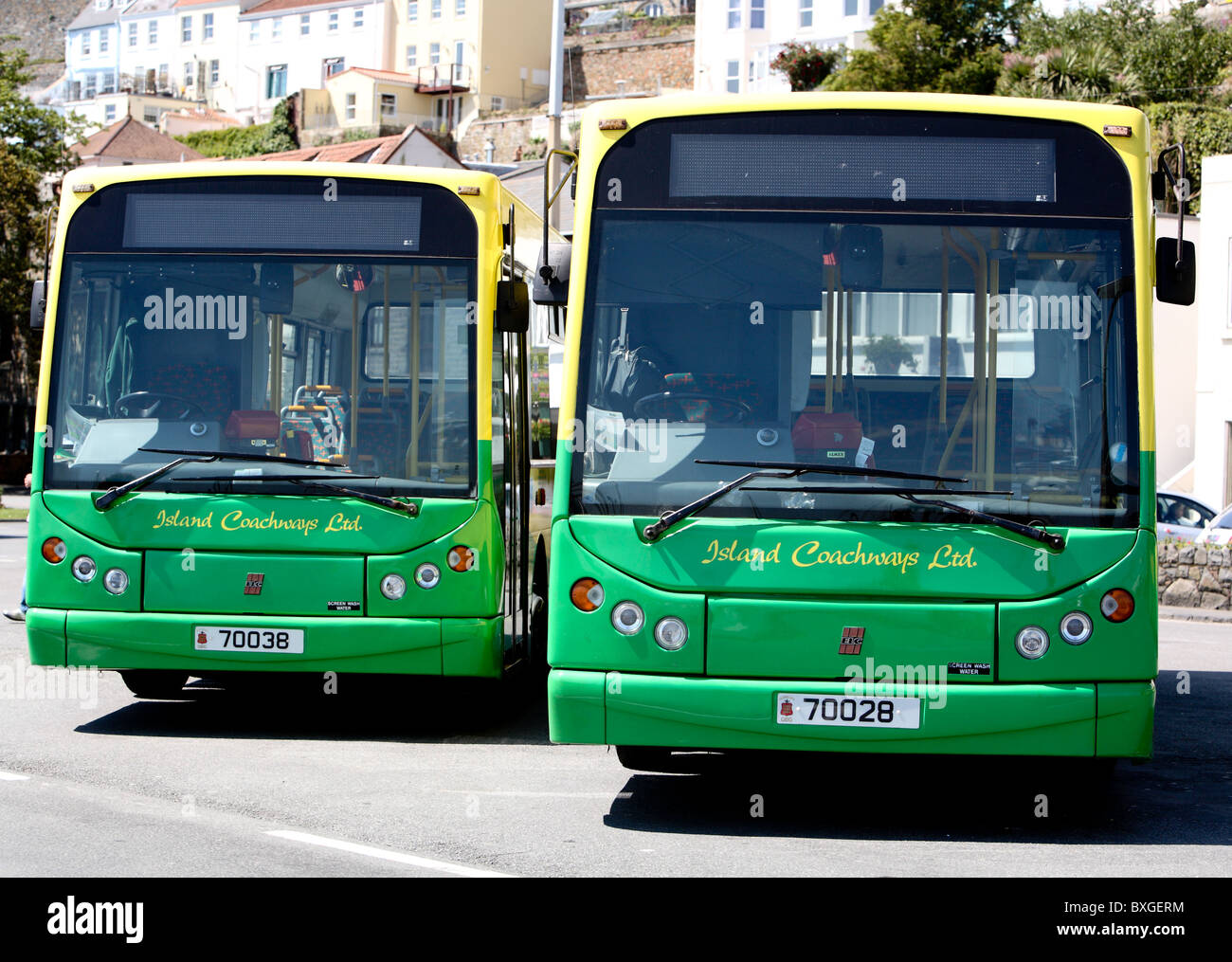 A couple of coaches/local island buses parked at the seafront St.Peter ...