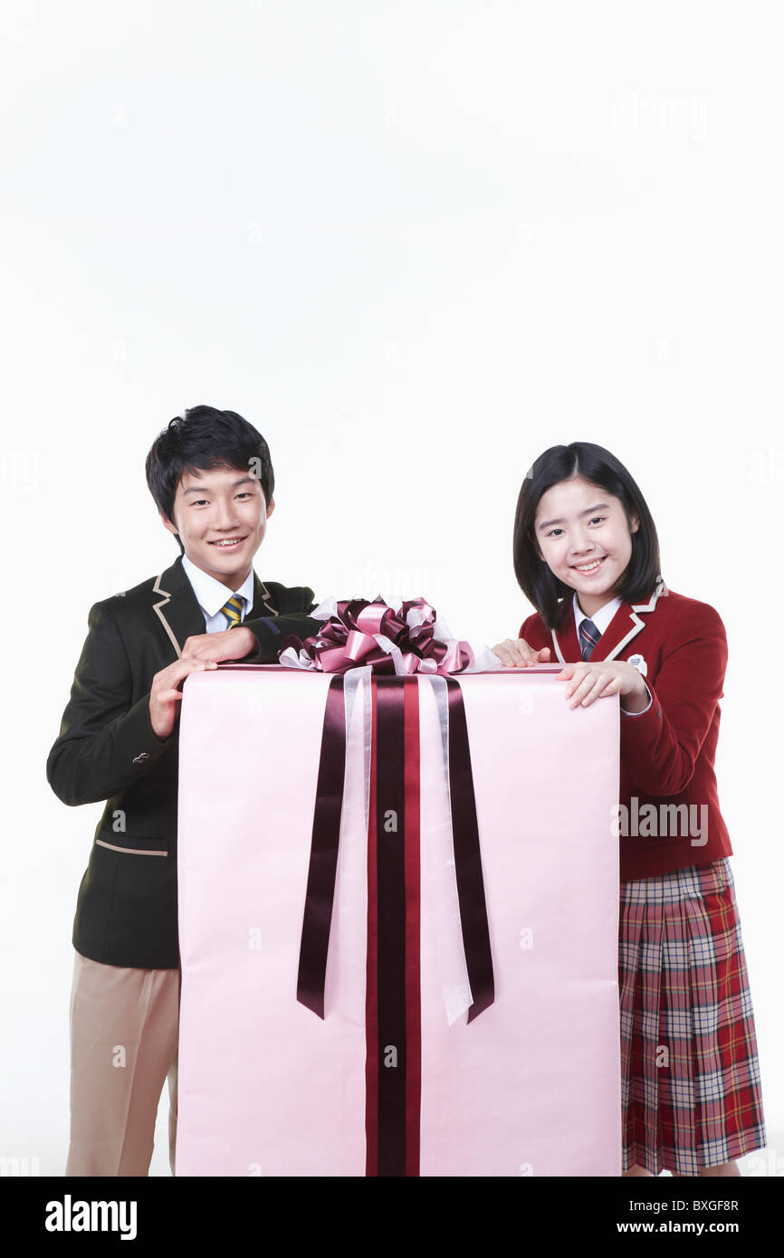 boy and girl hold a big present Stock Photo - Alamy