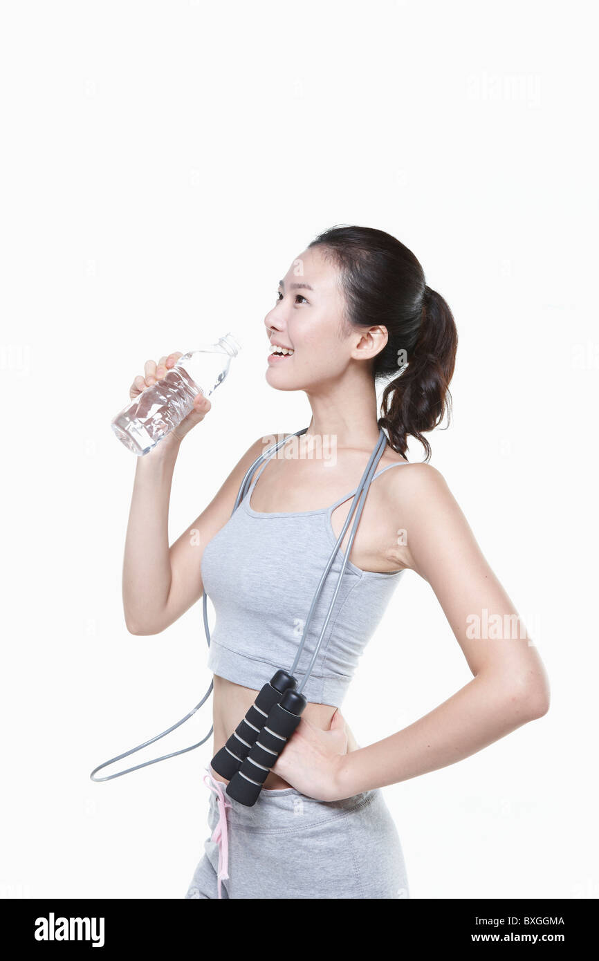 woman drinking water after exercise Stock Photo - Alamy